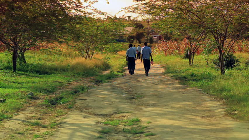 KENYA, AFRICA - CIRCA 2011: School Boy Walking At Dawn In Kenya, Africa ... KENYA, AFRICA - CIRCA 2011: School Boy Walking At Dawn In Kenya, Africa ...