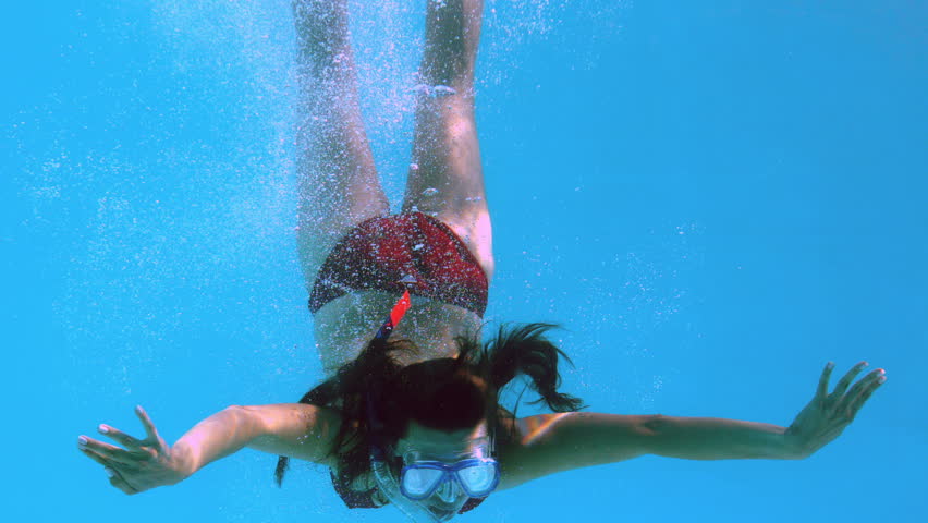 Happy Brunette Underwater In Swimming Pool Wearing Snorkel In Slow