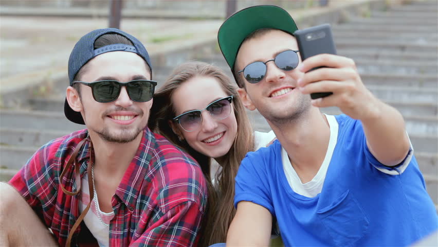Bright And Cheerful Day Young Friends Have Fun Together On The Street And Smile At Each Other