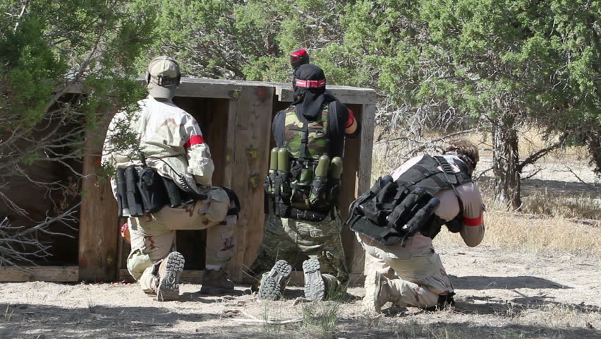 Paintball Shooters Behind A Barrier Barricade Shooting At Enemy ...