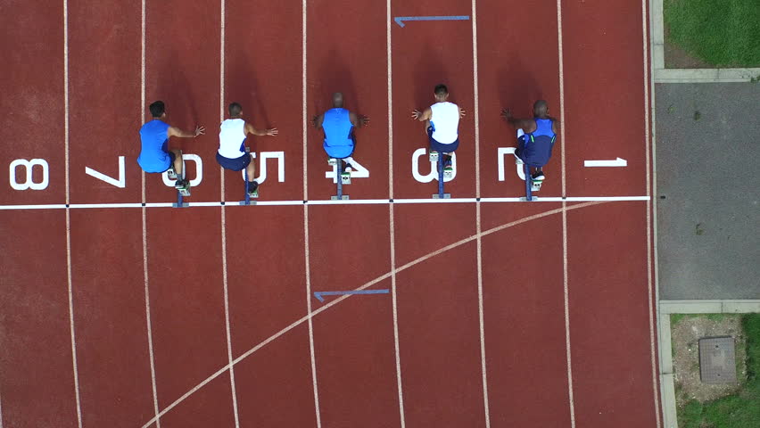 4K Aerial View Of Track Athletes At Running Track, Competing In A Race ...