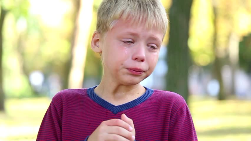 Portrait Of 8 Years Old Boy Crying And Looking At Camerae. Family ...