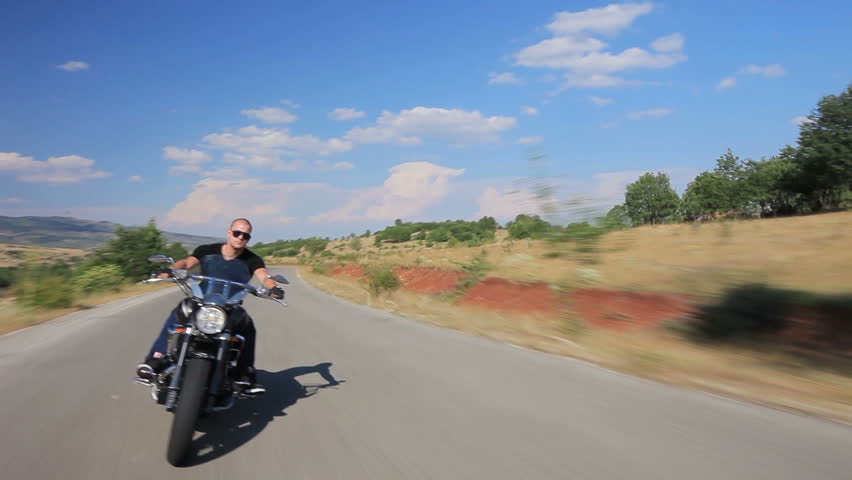 A Biker Riding A Customized Motorcycle On An Open Road Stock Footage ...