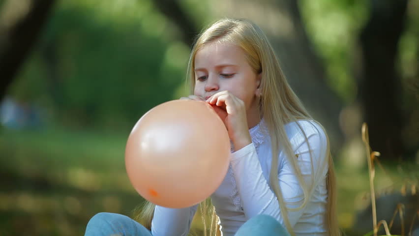 Child Blowing Up A Balloon Outdoors Stock Footage Video 3091741 ...