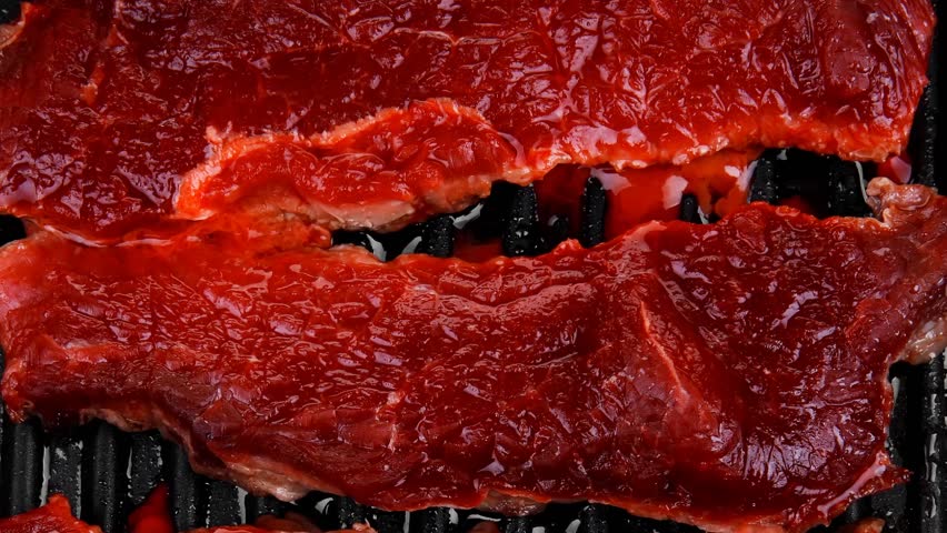 Fresh Raw Bloody Beef Steaks On Black Grill Plate Stock Footage Video ...