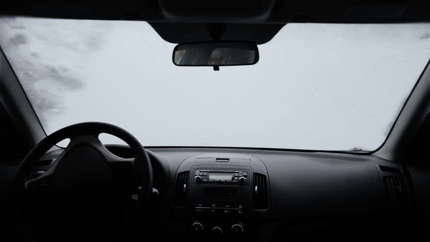 View From Inside A Car Of A Man Removing Snow Of The Windshield During ...