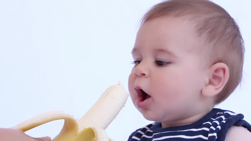 Baby Boy Is Eating A Banana N A White Background Stock Footage Video ...