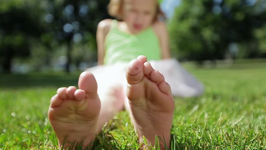 Closeup Of Little Girl's Feet, Her Big Toe Has A Smiley Face Drawn On ...